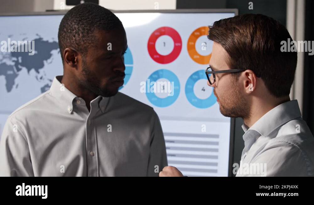 Two colleagues discussing business strategy on infographics background ...