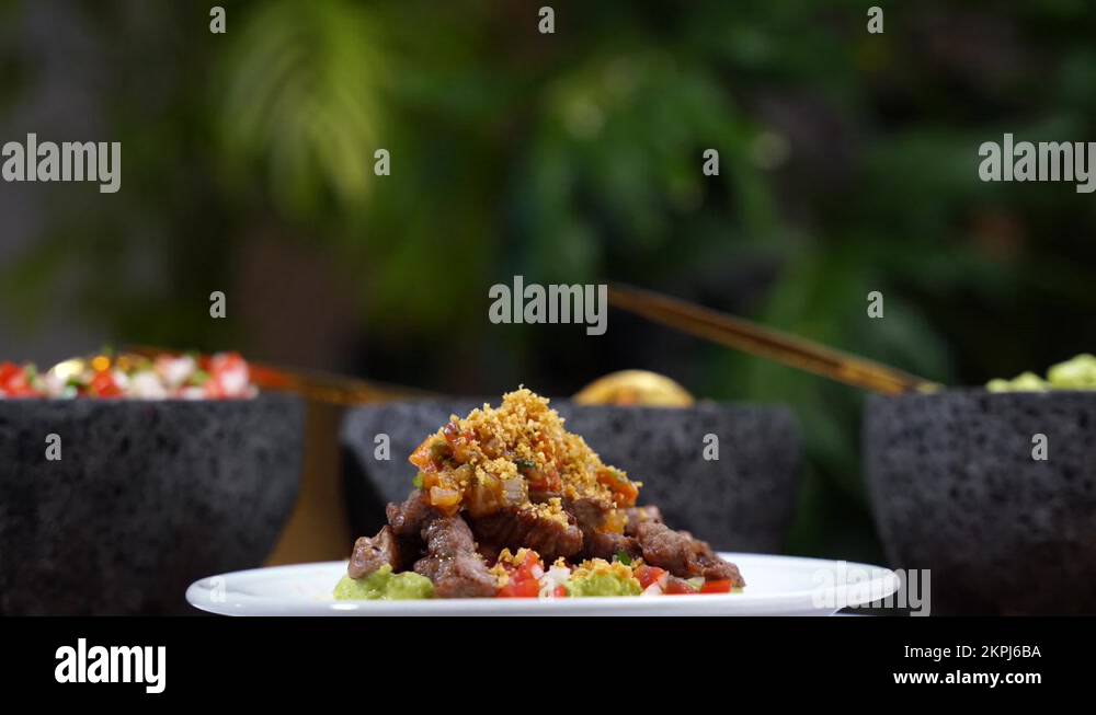 Mexican beef taco with avocado guacamole chicharron beans spinning in a ...