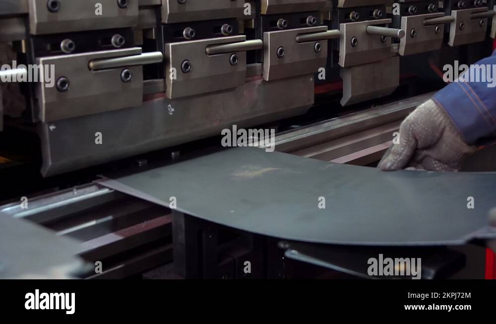 Automated Machine is bending the long sheet of metal at the production ...