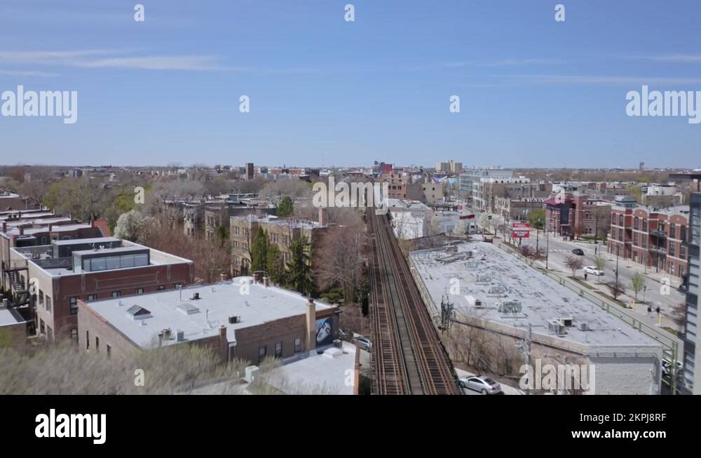 Gray subway rides at high speed on an elevated subway track as the ...