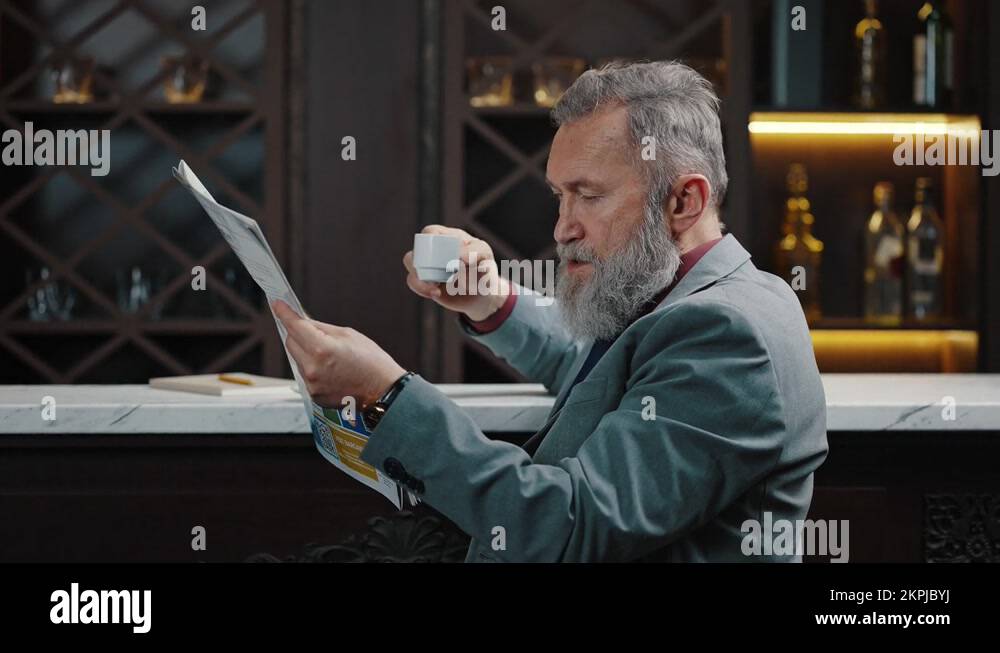 Morning of successful businessman. Mature man ceo in suit drinking ...