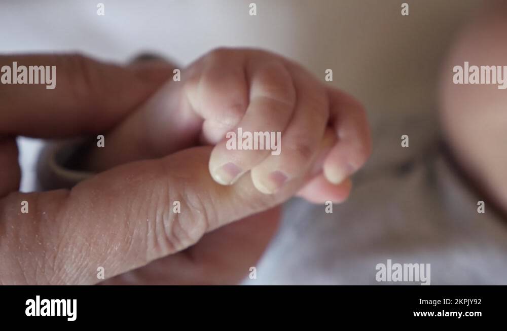 Mother holds tiny hand of newborn baby girl in bedroom Stock Video ...