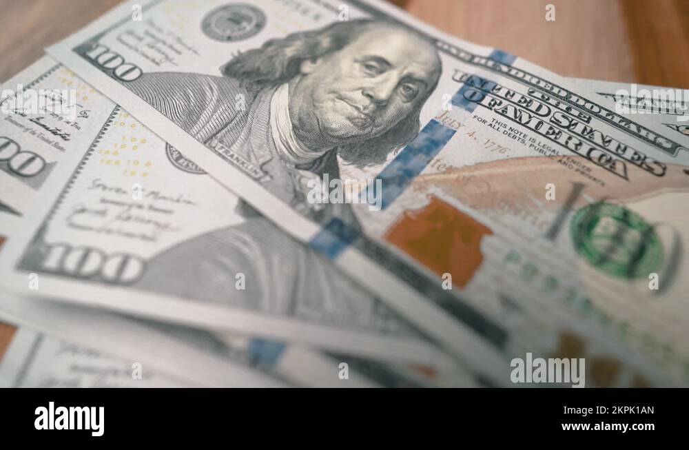 100 dollar bills falling on top of each other extreme close-up shot ...