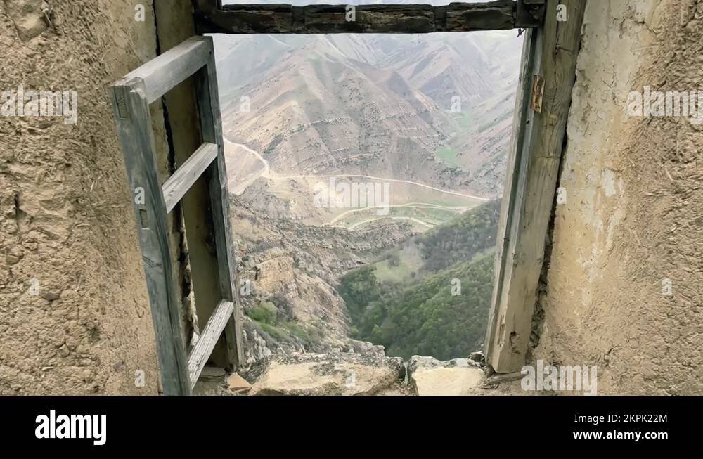 Camera flying through window in ancient wall of abandoned village ...