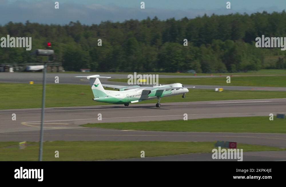 commuter propeller airplane dash 8 q400 wideroe taking off slow motion ...