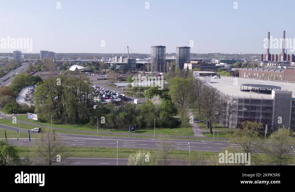 Tilt up of autostadt museum in Wolfsburg with carpark and Turmfahrt ...
