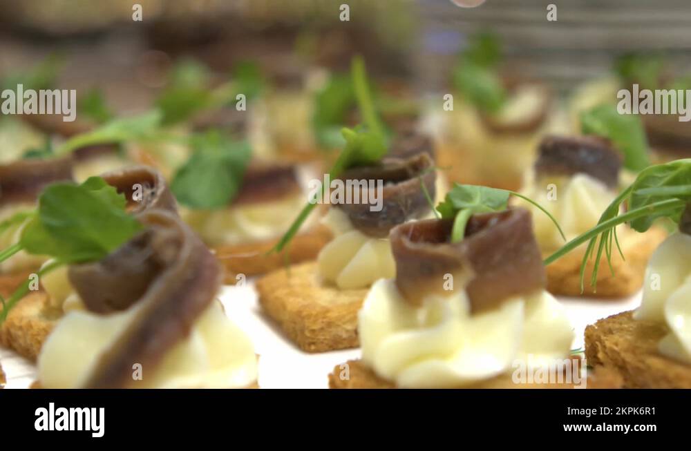 Canapé with butter, anchovy and salad, finger food served at a ...