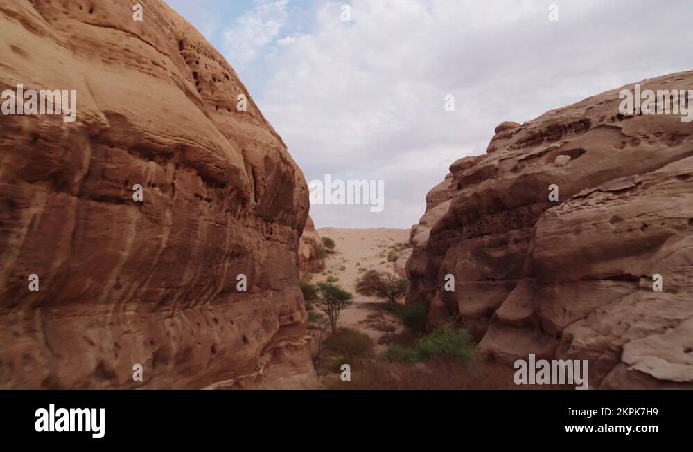 Top down and reveal flying through rock canyons in desert. 4K Aerial ...
