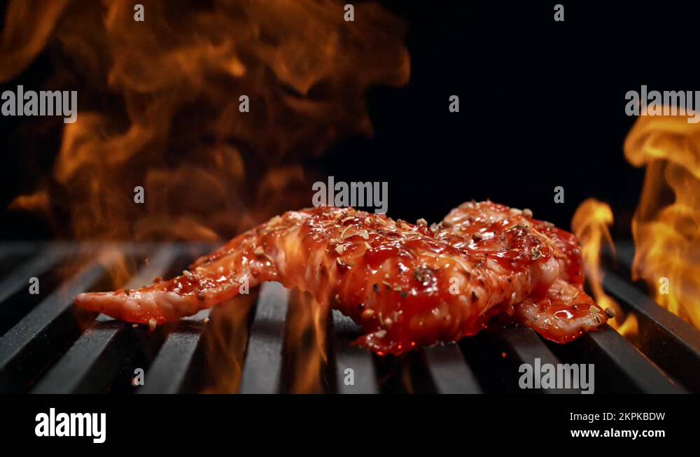 Marinated Chicken Wing Falling onto Grill Grate - BBQ on Black ...