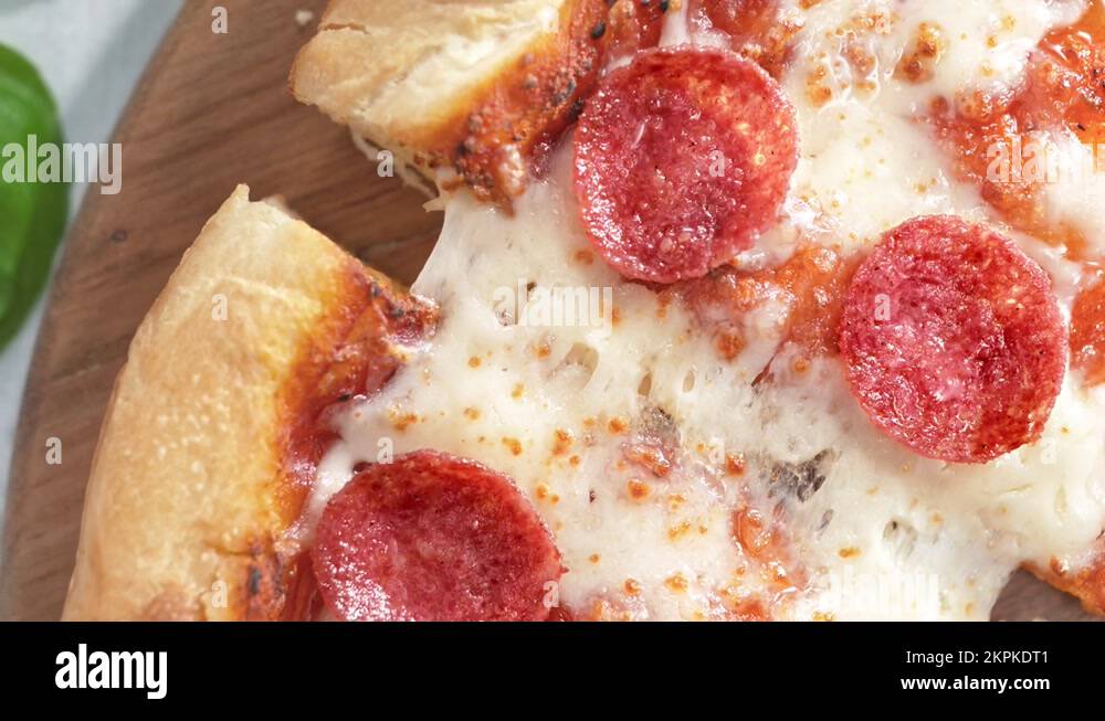 Tearing Slice of Pepperoni Pizza - Table Top View of Stretchy ...