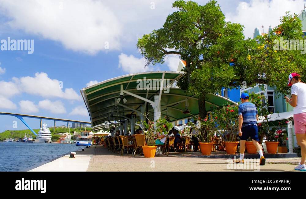 Cafe by the waterfront of the stunning Saint Anna Bay and Queen Juliana ...