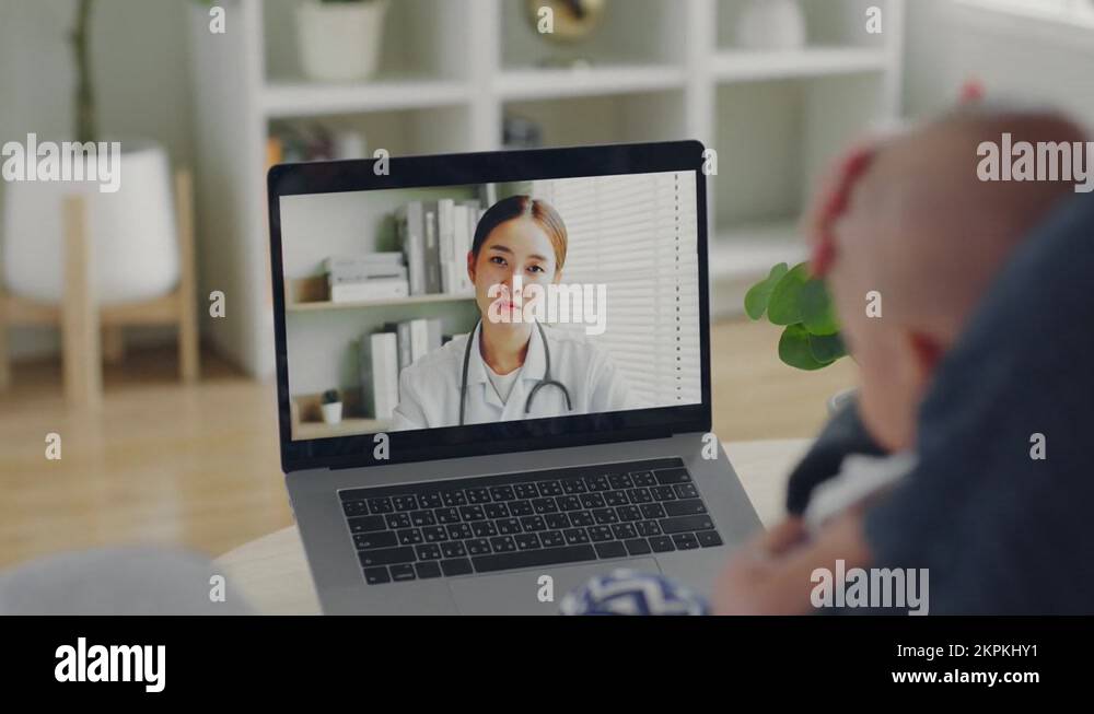 Mother with baby making video call, talking with doctor, telehealth ...