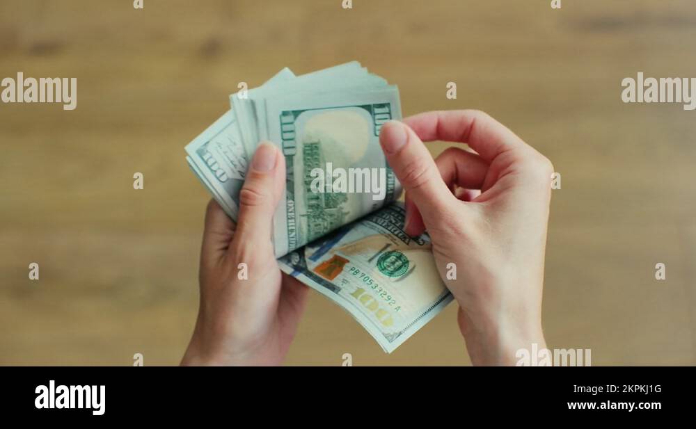 Woman counts hundred dollar bills Stock Videos & Footage - HD and 4K Video Clips - Alamy
