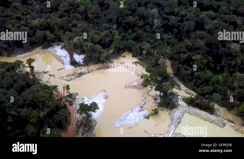 drone filming over the mining pools in the amazon rain forest Stock ...