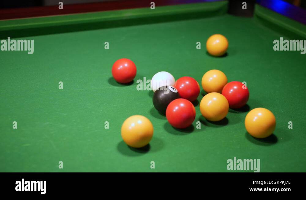 Close up of a pool break. A man hits the white ball into a triangle of ...