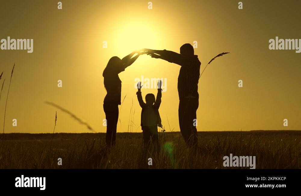 Silhouette of teamwork, happy family shows house with their hands ...