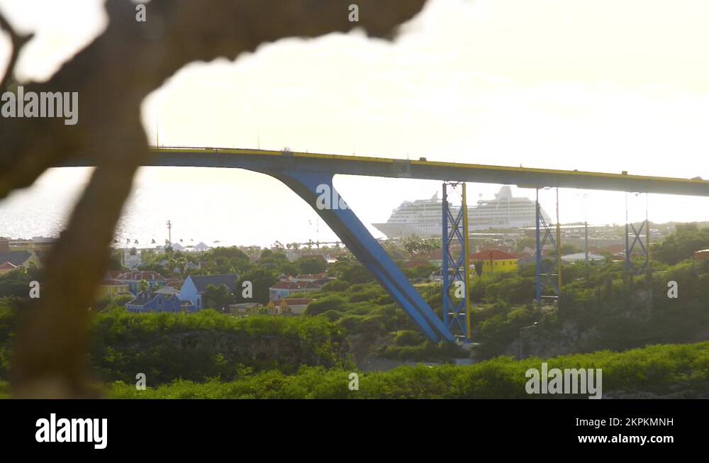 Queen Juliana Bridge back lit by a beautiful sunset over Saint Anna Bay ...