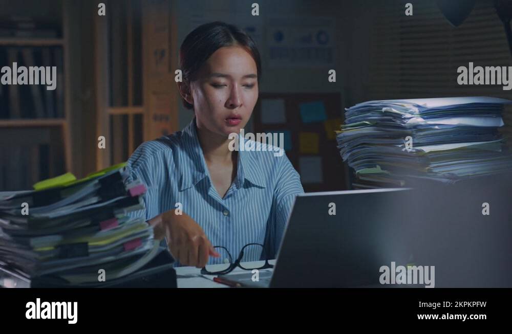 Young Asian office employee tired, fatigue, exhausted while working at ...