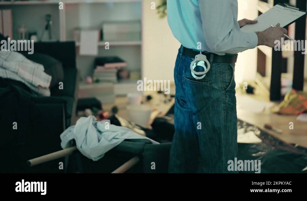 Police investigator examining crime scene in room, filling out report ...