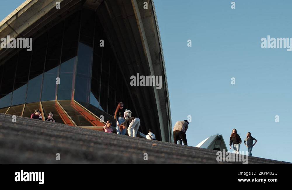Two sisters walking down the steps of Sydney Opera House slow motion 4K ...