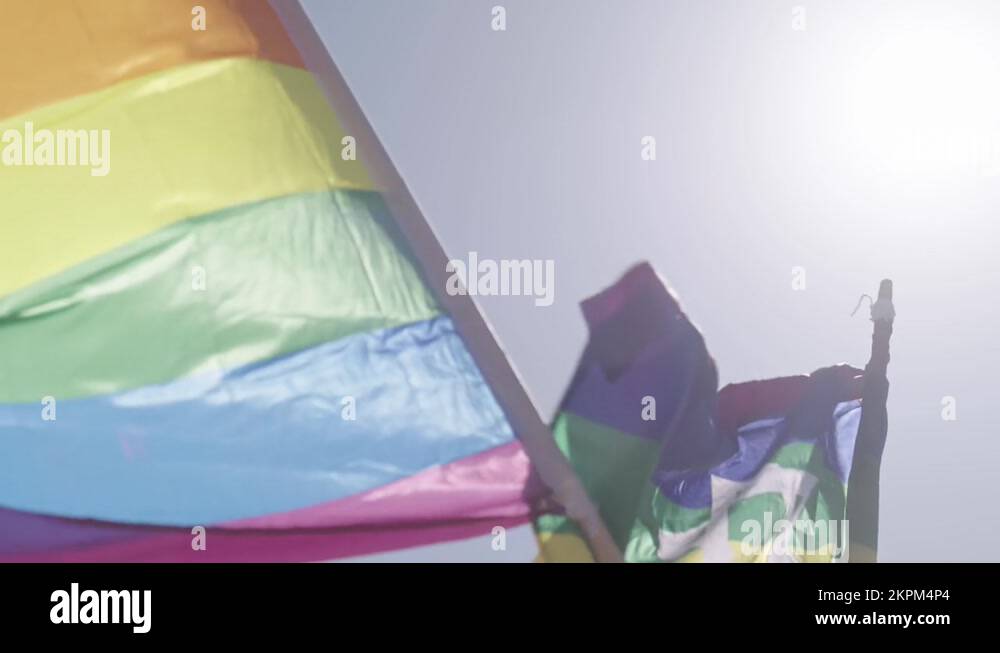 LGBTQ rainbow flags with a star of david waving in slow motion against ...