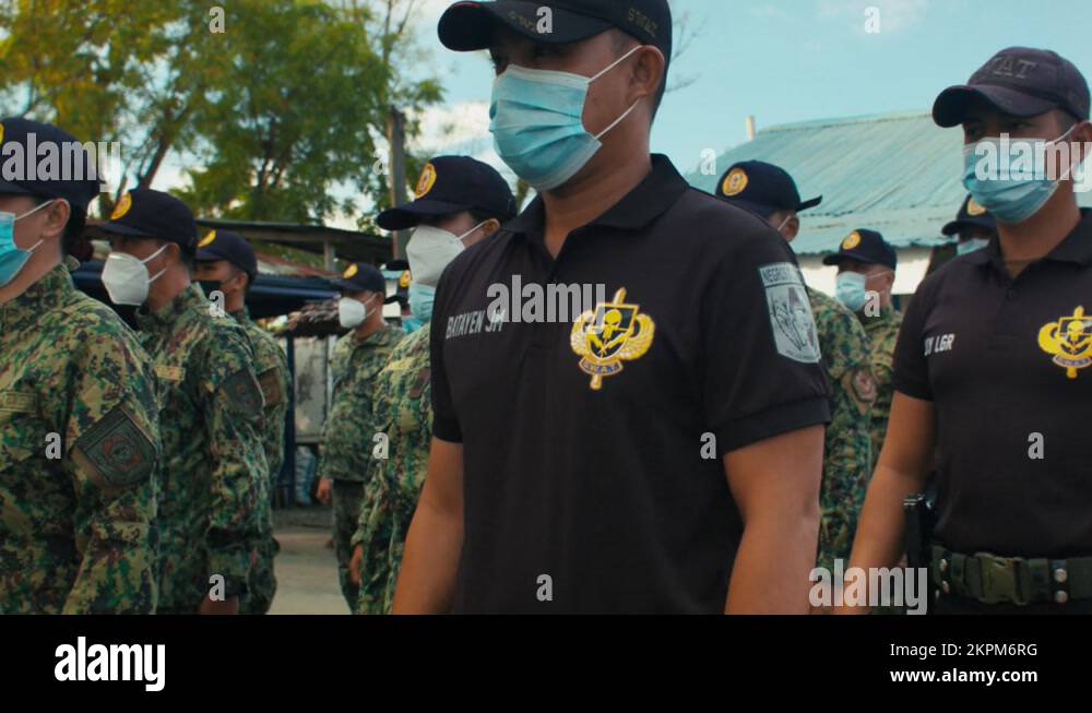 Philippine National Police officers attend a flag ceremony amidst a ...