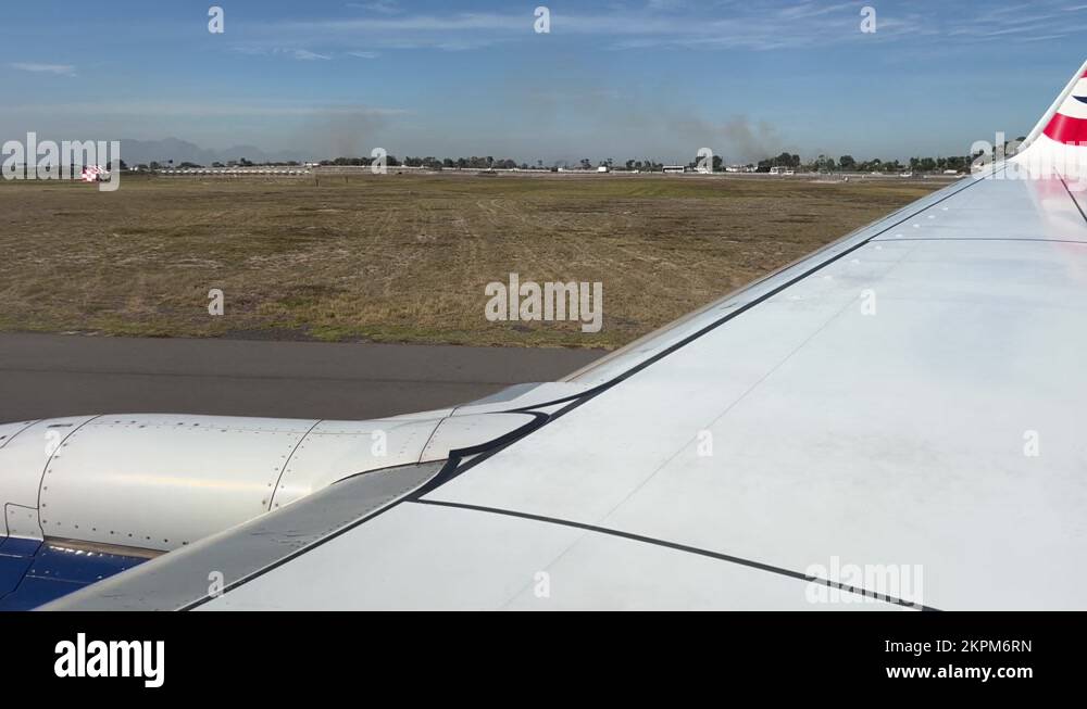 Airplane on the runway ready for takeoff next to a busy freeway Stock ...
