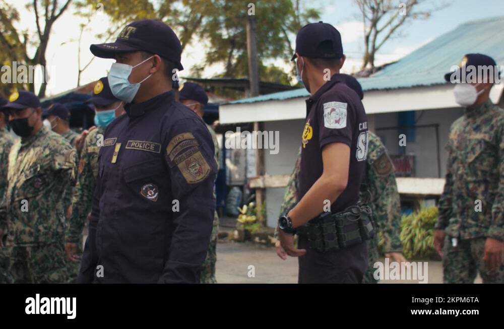 Philippine National Police officers attend a flag ceremony amidst a ...