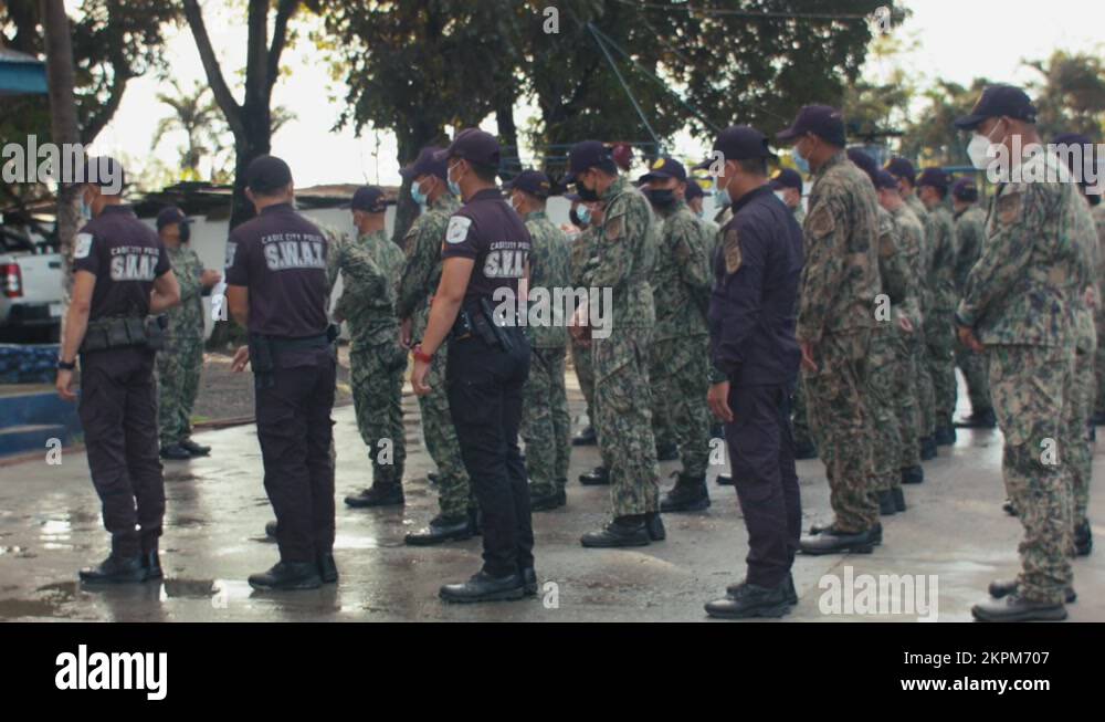 Philippine National Police officers attend a flag ceremony amidst a ...