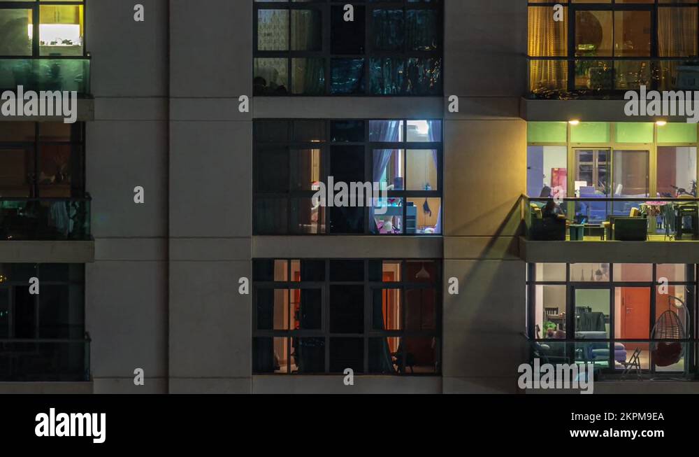 Windows of apartment building at night timelapse, the light from ...