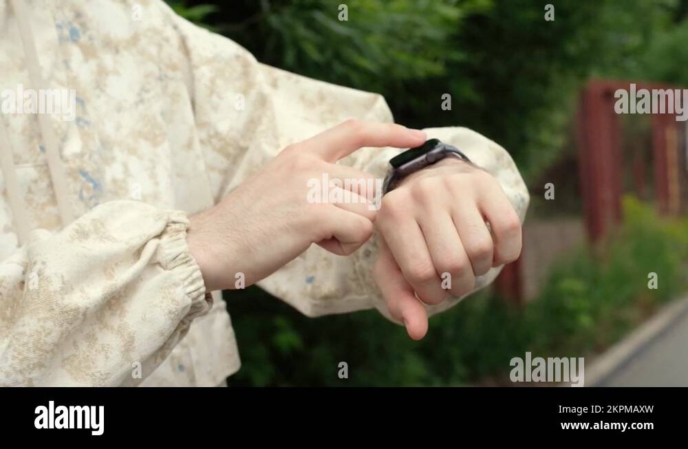 Smart watch on a man's hand. Man touching a smart band screen, checking ...