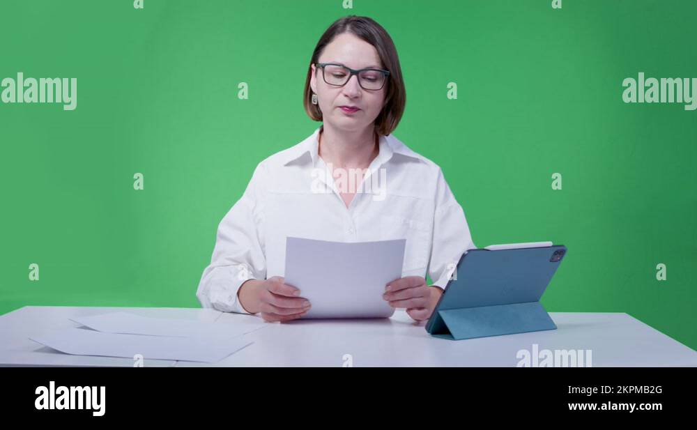 TV presenter reads breaking news holding papers at table Stock Video ...