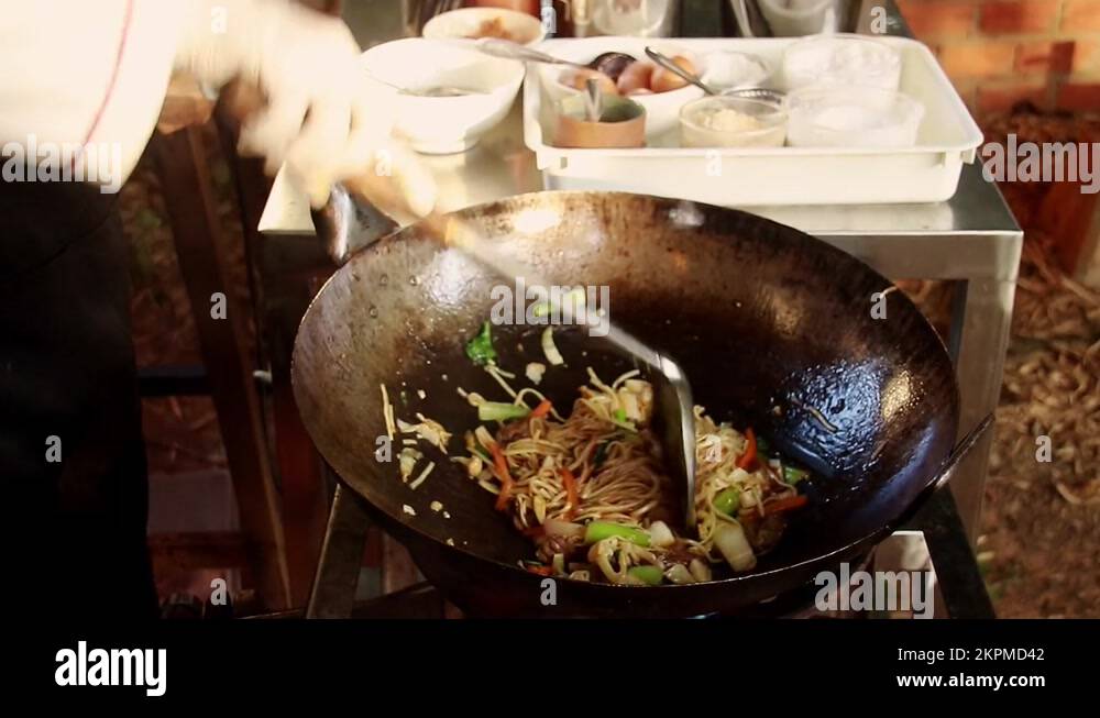 Kuy Teav Cha or Cambodian stir-Fried egg noodle being cooked in a Stock ...