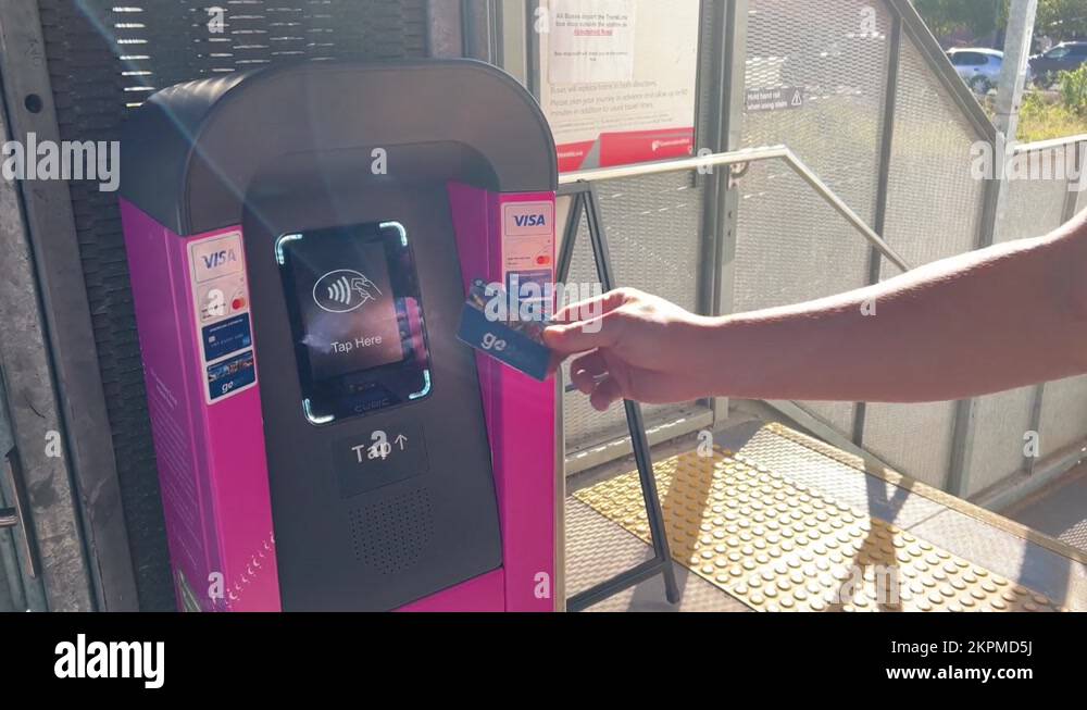Faceless male hand tapping on the ticketing machine to touch on and off ...