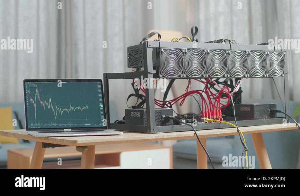 A Green Screen Laptop Is On The Table With Mining Rig For Mining ...