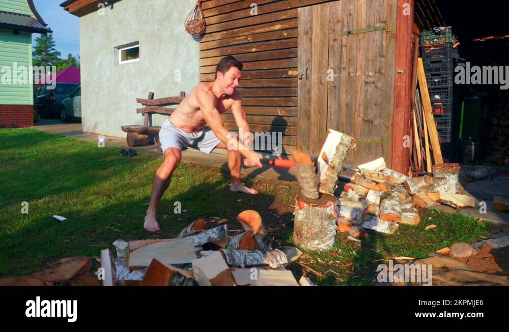 Young Man Splitting Wood With An Axe. - slow motion Stock Video Footage ...