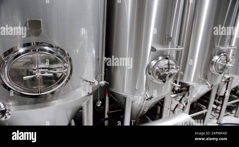 Stainless steel tanks for brewing beer. Huge stainless vats in a ...
