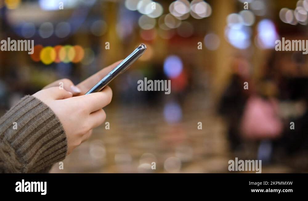 Shopping center. Moll. Finger of woman touching scroll page app on mobile phone Stock Video ...