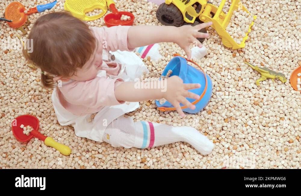 2-year-old Girl Throwing Beach-sand Like From Toy Bucket At Kid's Cafe ...