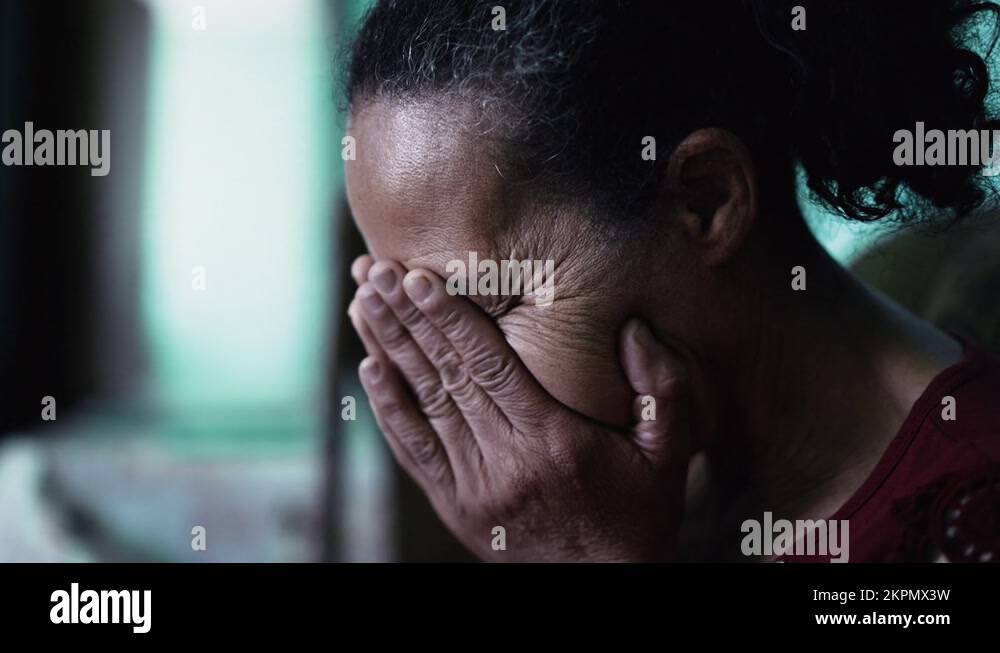 One sad depressed senior woman covering face with hands feeling regret ...