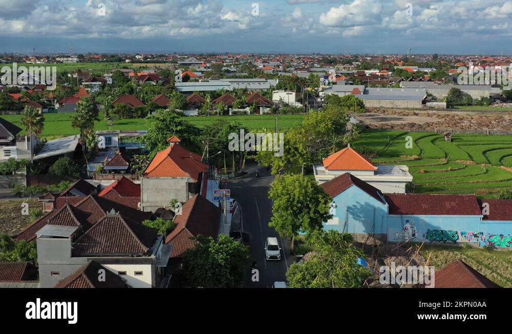 cars and motorbikes driving in bali indonesia surrounded by rice fields ...