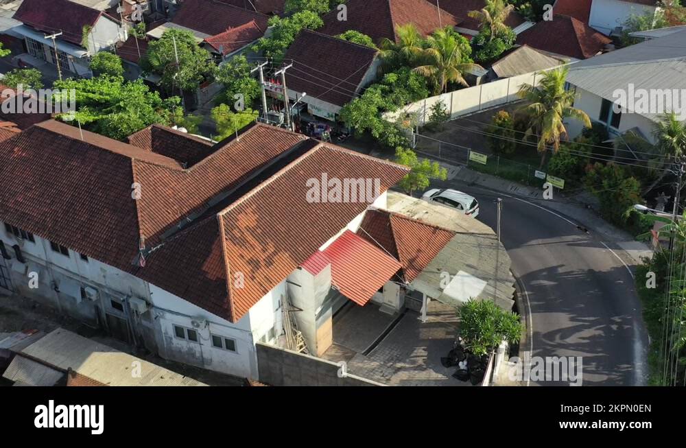 traffic turning around a corner in bali indonesia during sunset, aerial ...