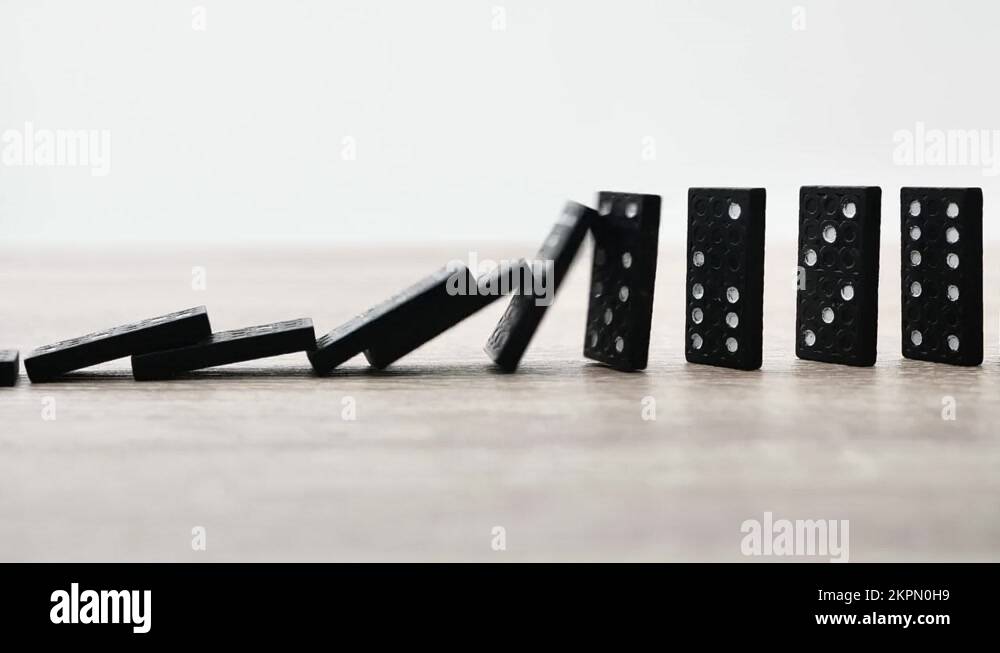 Domino effect in slow motion - falling black tiles with white dots ...