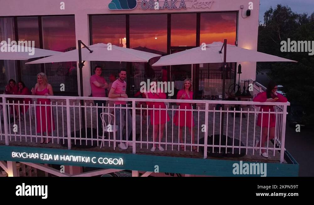 A group of people are celebrating a birthday on the second floor of a ...