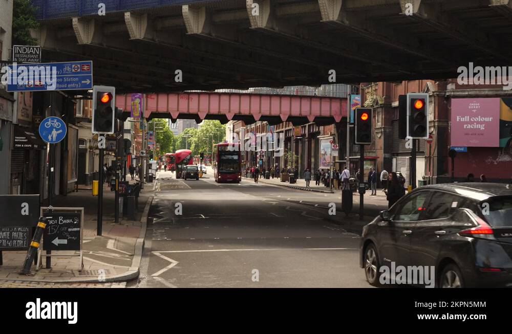 London double decker bus riding underneath viaduct. London, England ...
