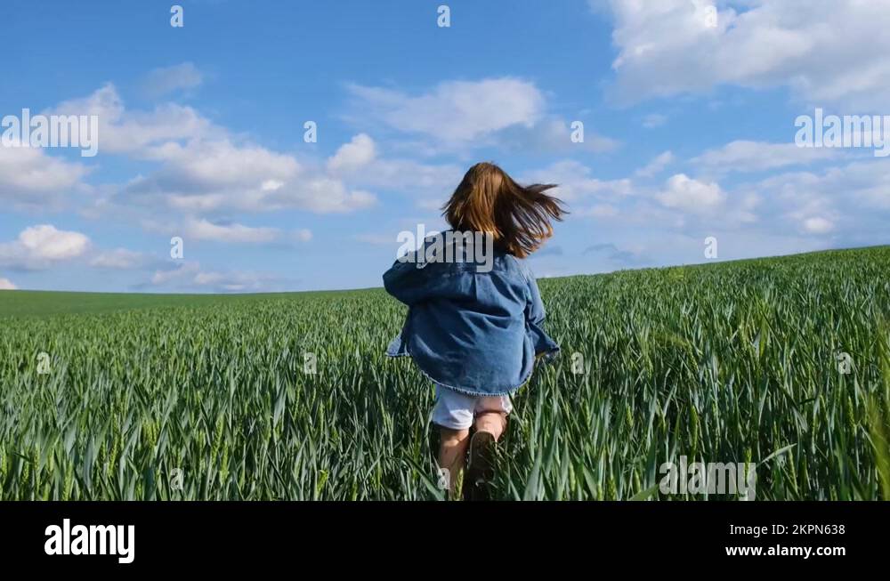 Young teen girl enjoys nature on the field. She runs under the open blue sky at Stock Video ...