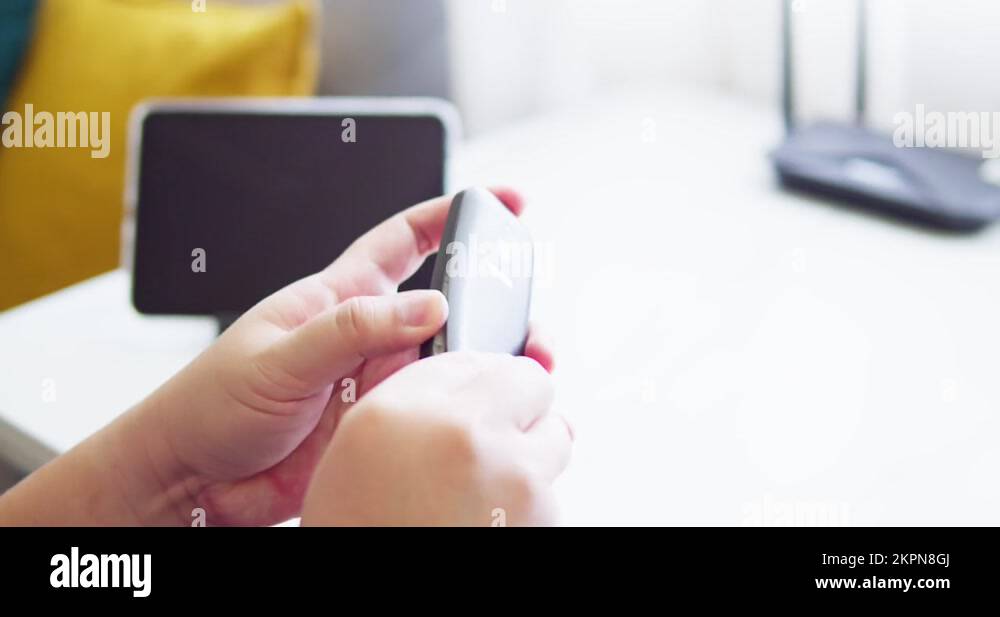 man holding old mobile NOKIA 3310 try to use and touch button and check ...