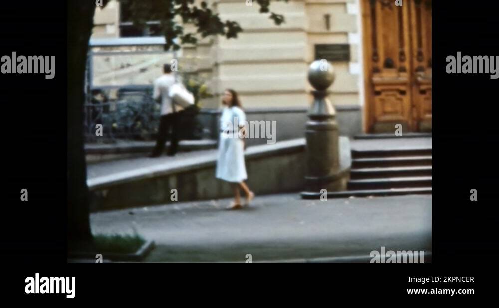 Woman walking on 80s Europe city street in summer. Person looking ...