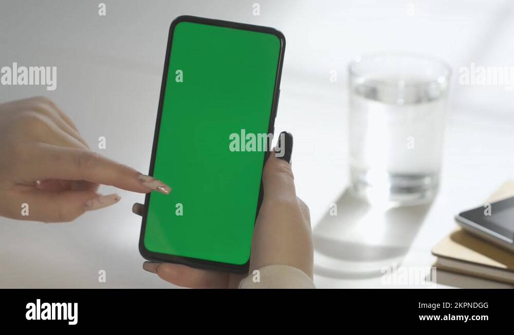 Handheld Camera: Back View of Brunette woman Holding Chroma Key Green ...