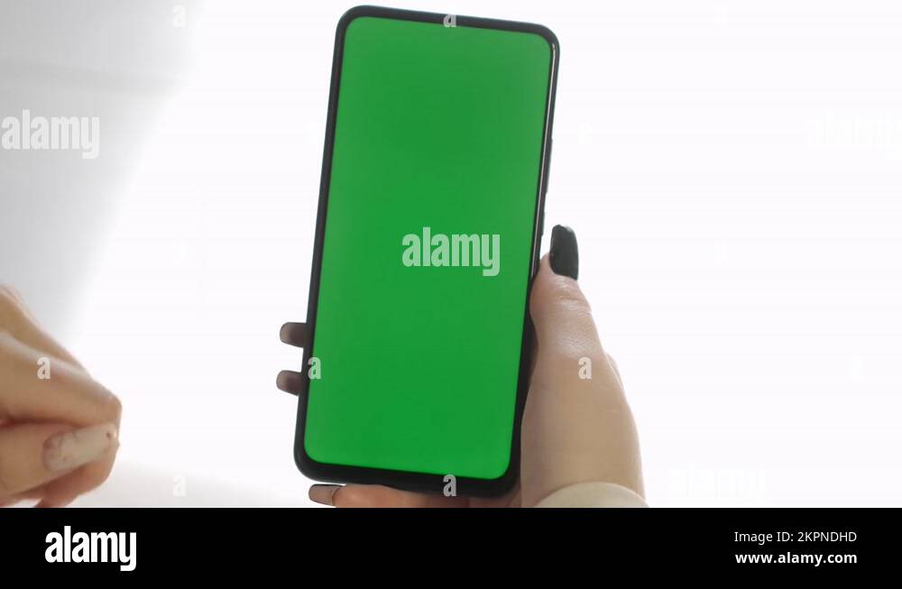 Handheld Camera: Back View of Brunette woman Holding Chroma Key Green ...